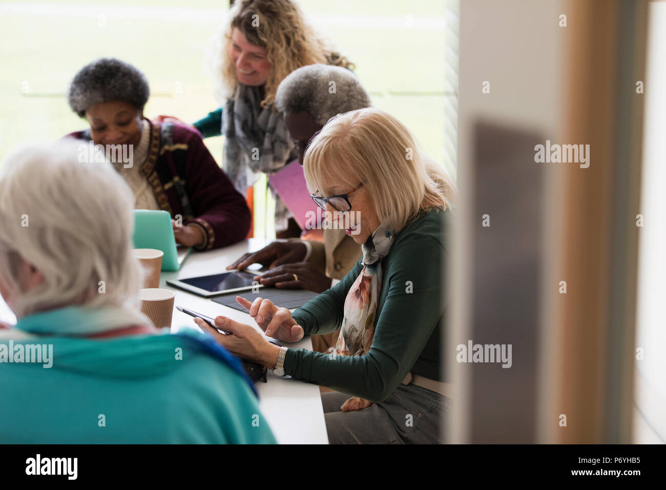 Senior business people working, using digital tablets in conference ...