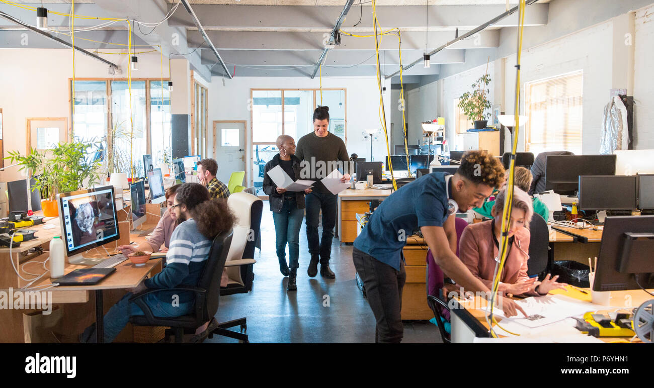 Creative business people working in open plan office Stock Photo - Alamy