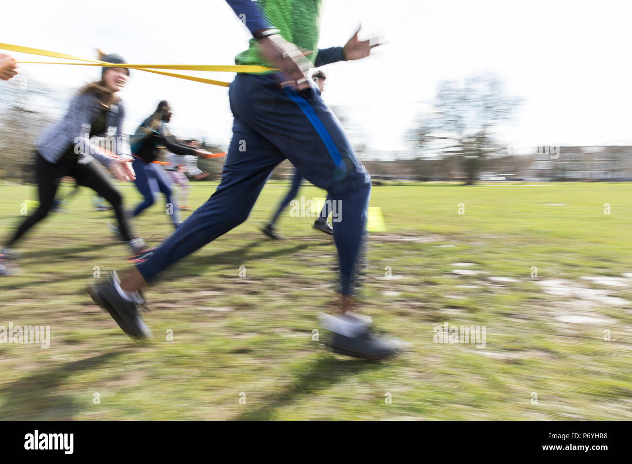People racing, doing team building exercise in sunny park Stock Photo ...