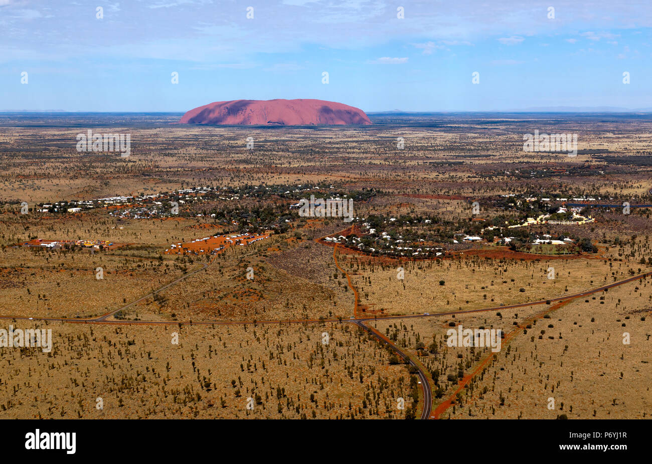 Aerial view of the town of Yulara with Uluru in the background Stock ...