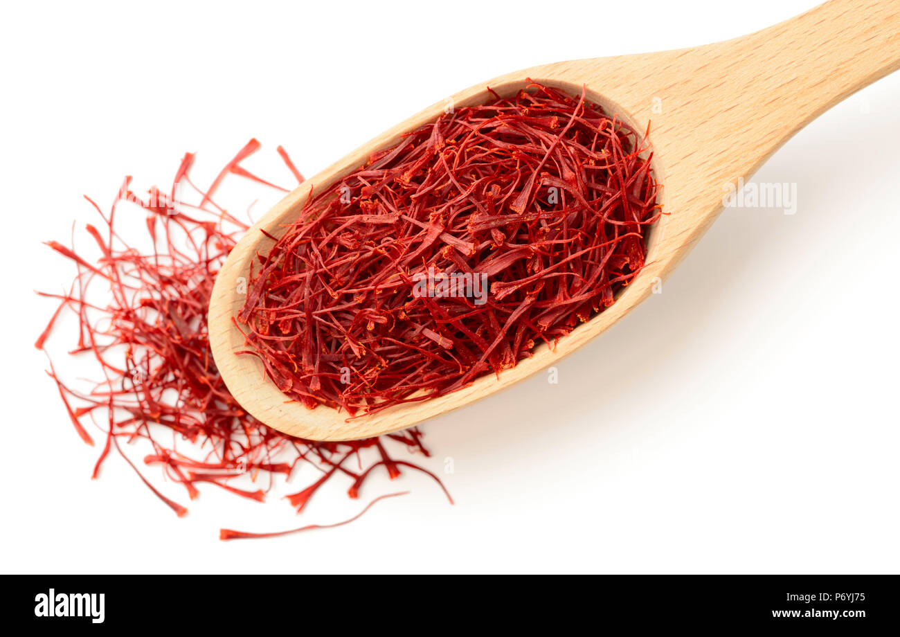 saffron thread in the wooden spoon, isolated on white background, top ...