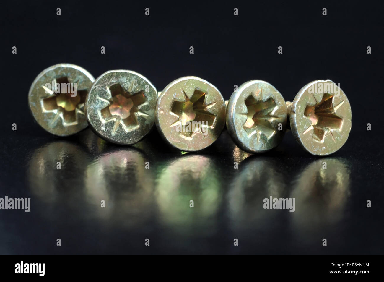 Metal screws of yellow color are arranged in a row Stock Photo - Alamy