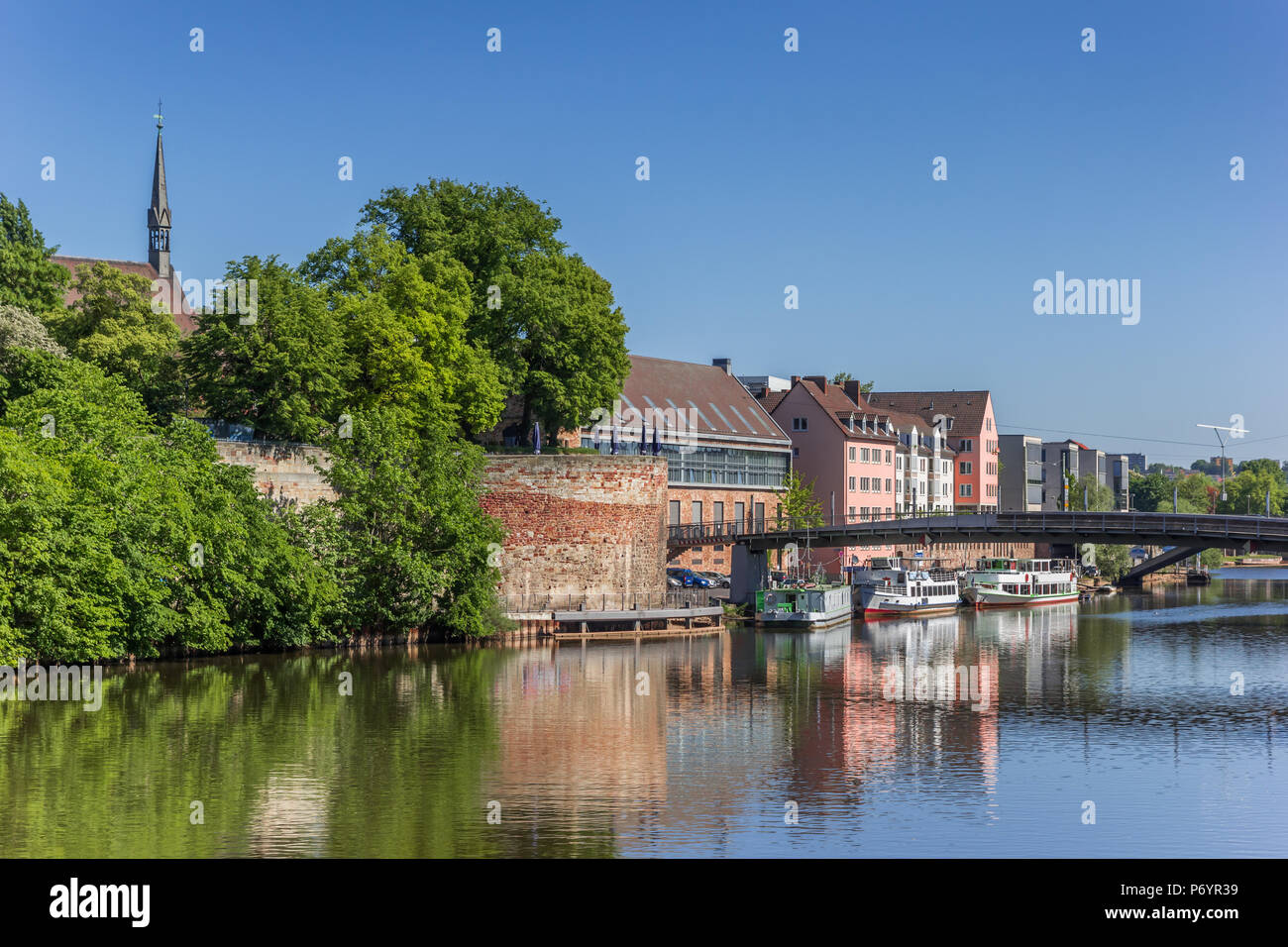 Colorful buildings and ships at the Fulda river quay in Kassel, Germany ...