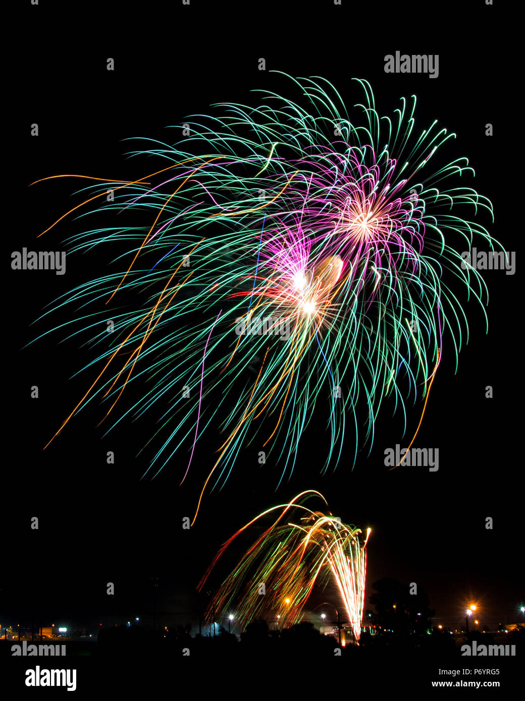 Windswept Multiple Colored Star burst fireworks and rocket trails from ...