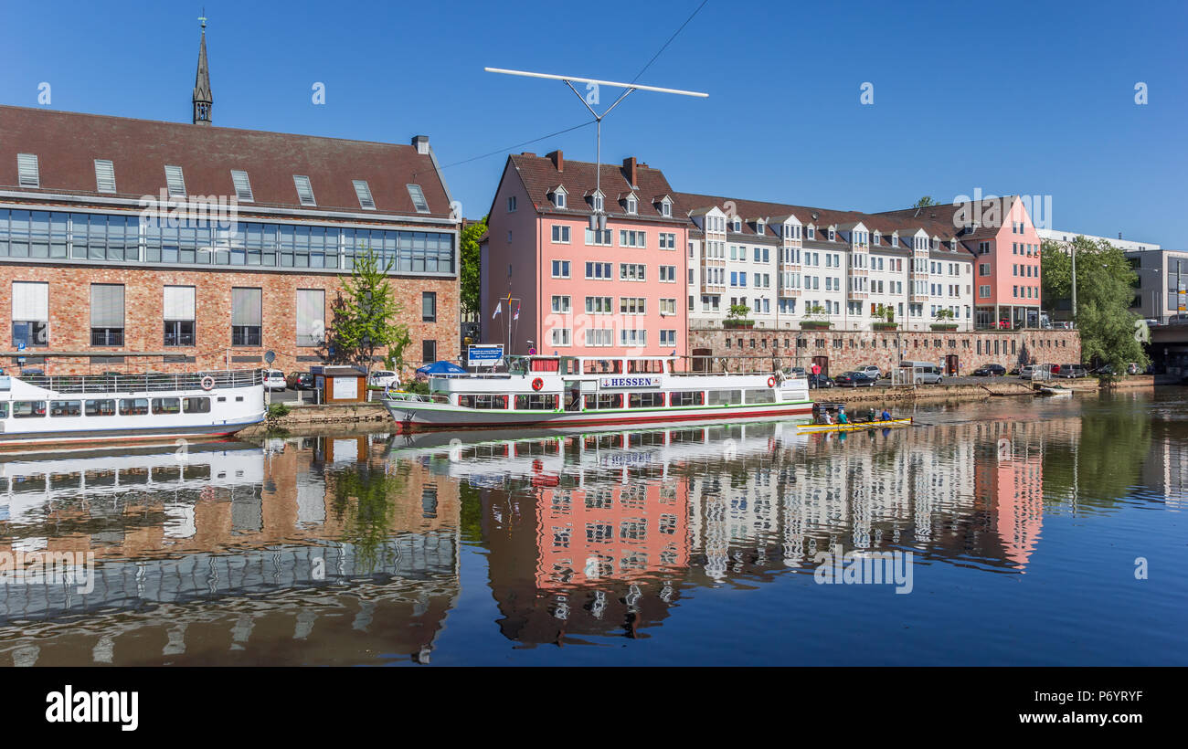 Colorful buildings and ships at the Fulda river quay in Kassel, Germany ...
