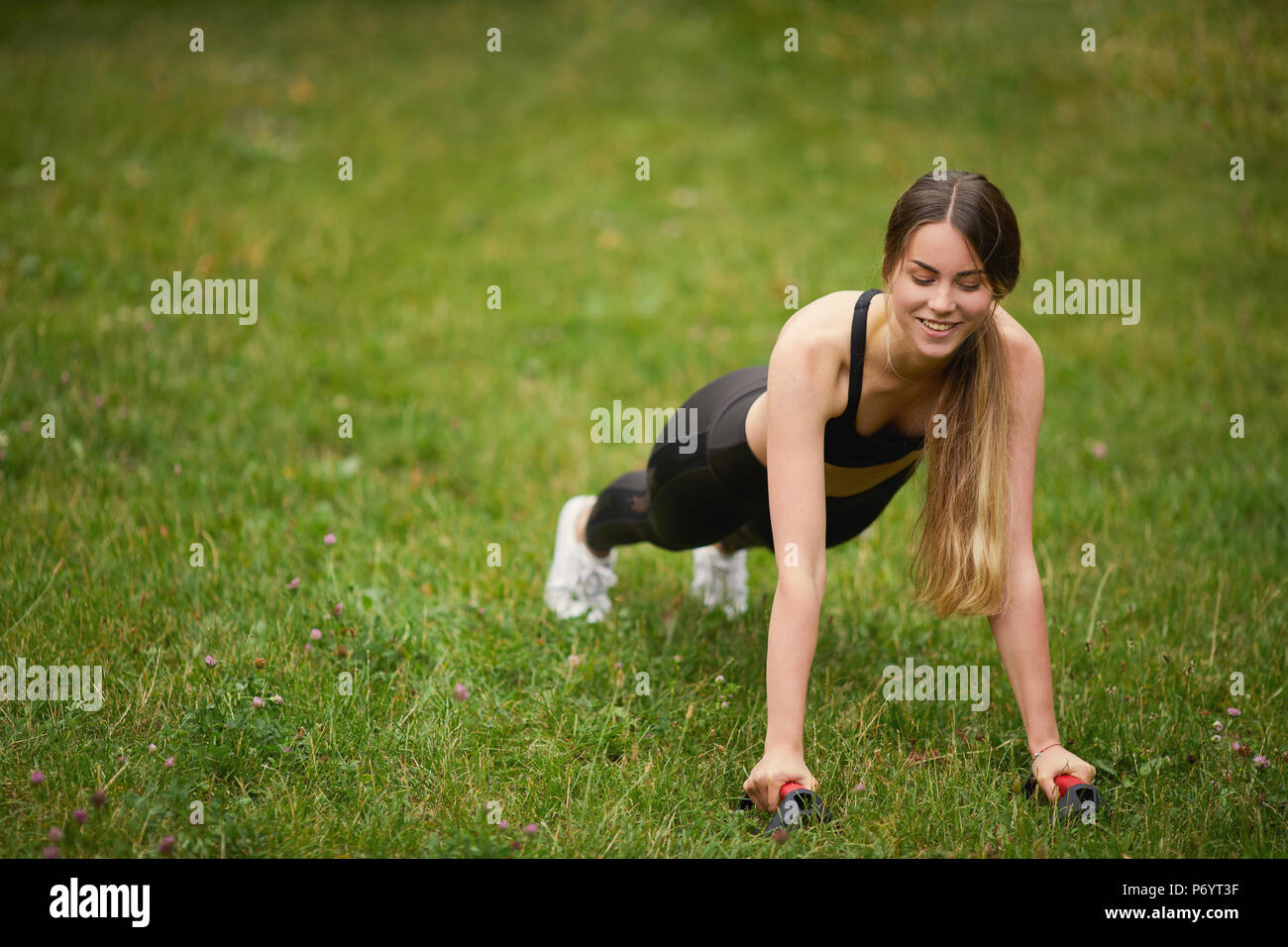 Pretty fit girl doing push ups on the park background Stock Photo - Alamy