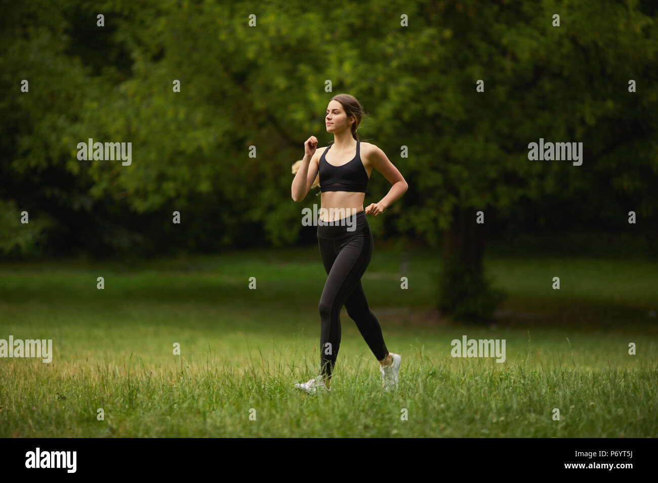 Fit pretty girl running on the park Stock Photo - Alamy