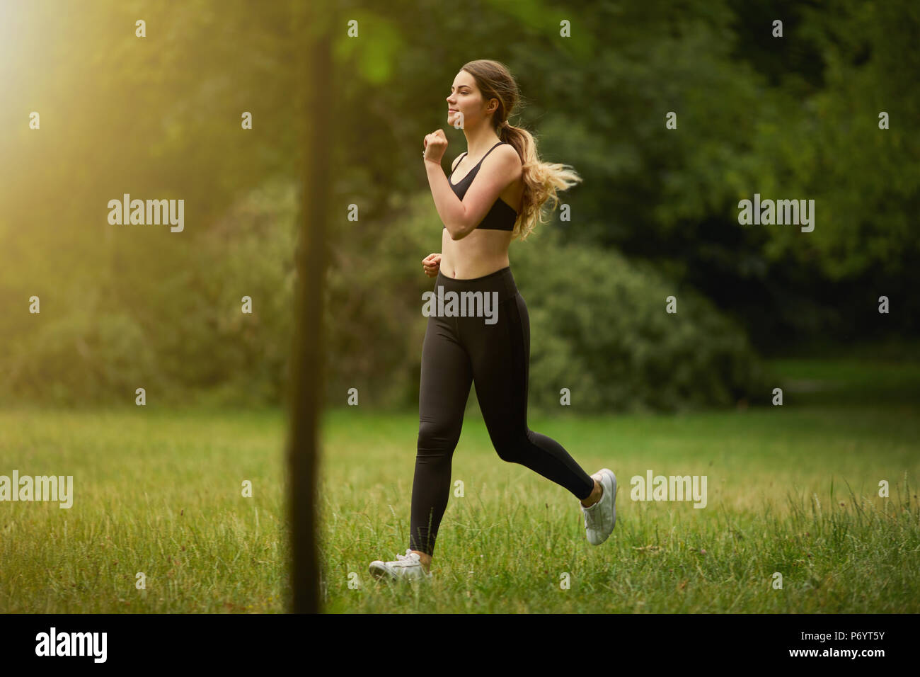 Fit pretty girl running on the park Stock Photo - Alamy