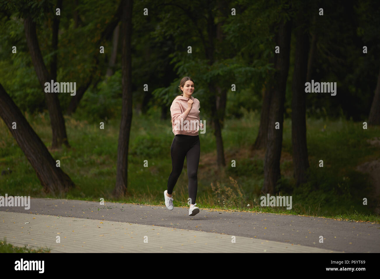 Fit pretty girl running on the park Stock Photo - Alamy