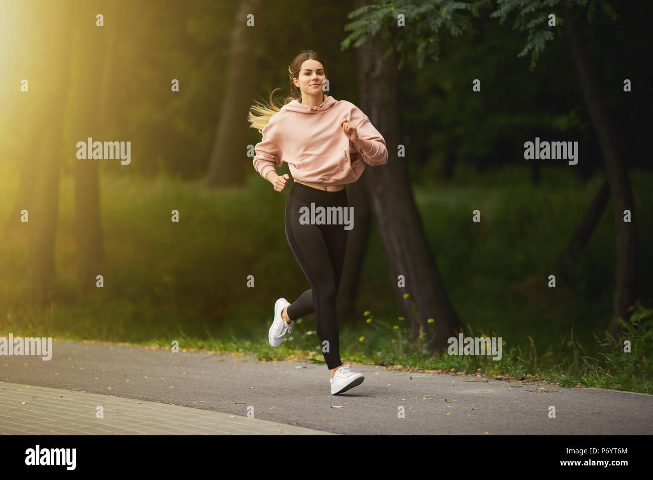 Fit pretty girl running on the park Stock Photo - Alamy