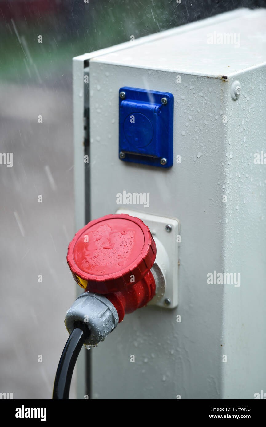 Raindrops are seen on industrial electric plug during heavy rain Stock ...