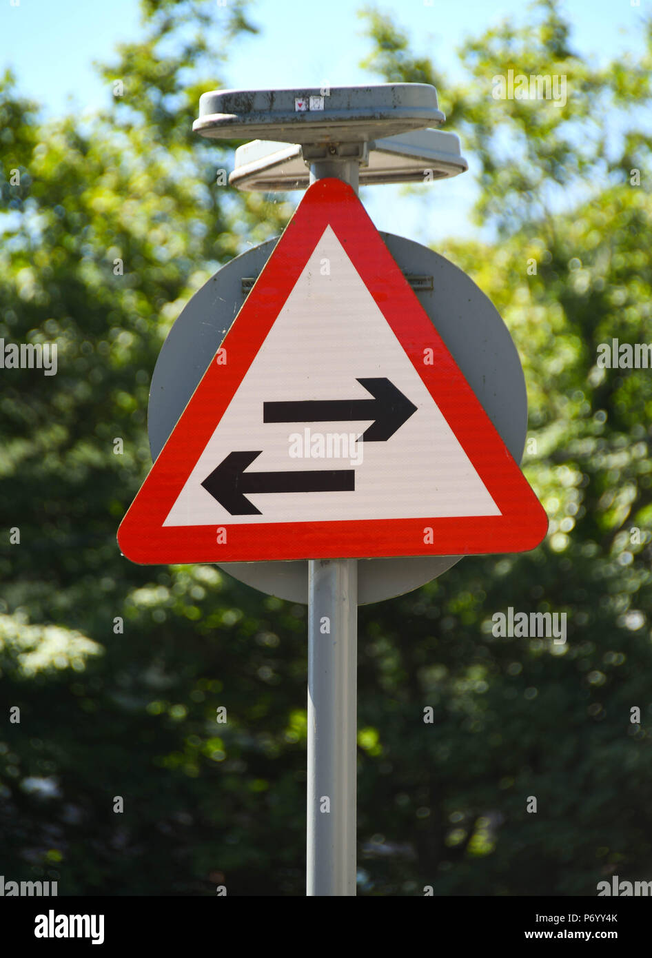 Road sign informing motorists of two way traffic at the junction ahead ...