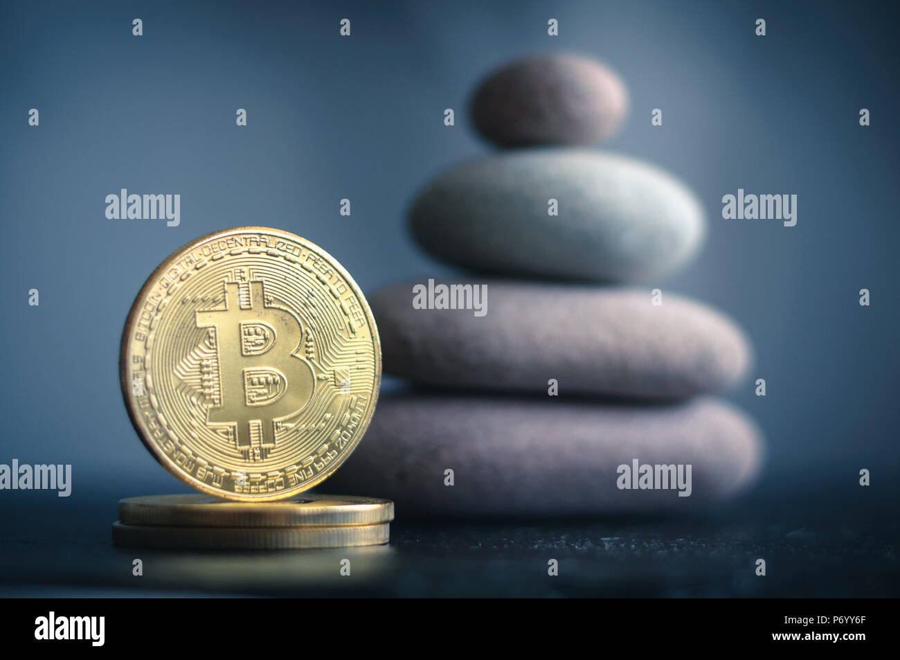 Golden bitcoin coin on the background of the pyramid of stones is a ...