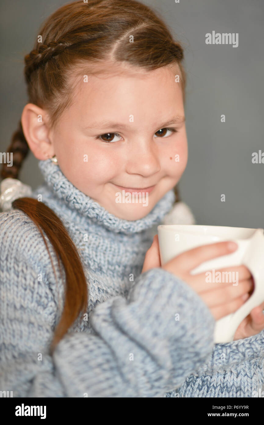 cute sick girl with cup of rea Stock Photo - Alamy