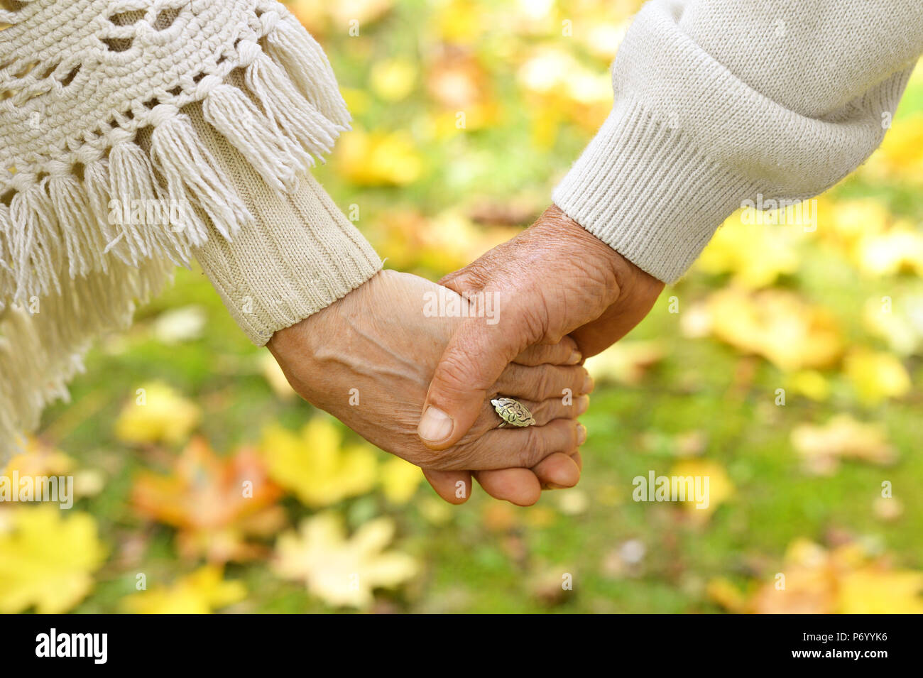 Elderly couple holding hands Stock Photo - Alamy