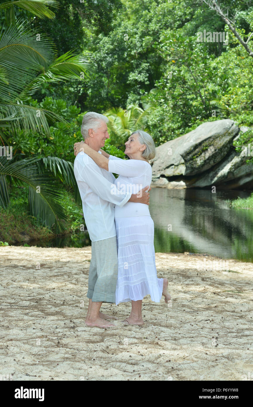 Happy elderly couple hugging Stock Photo - Alamy