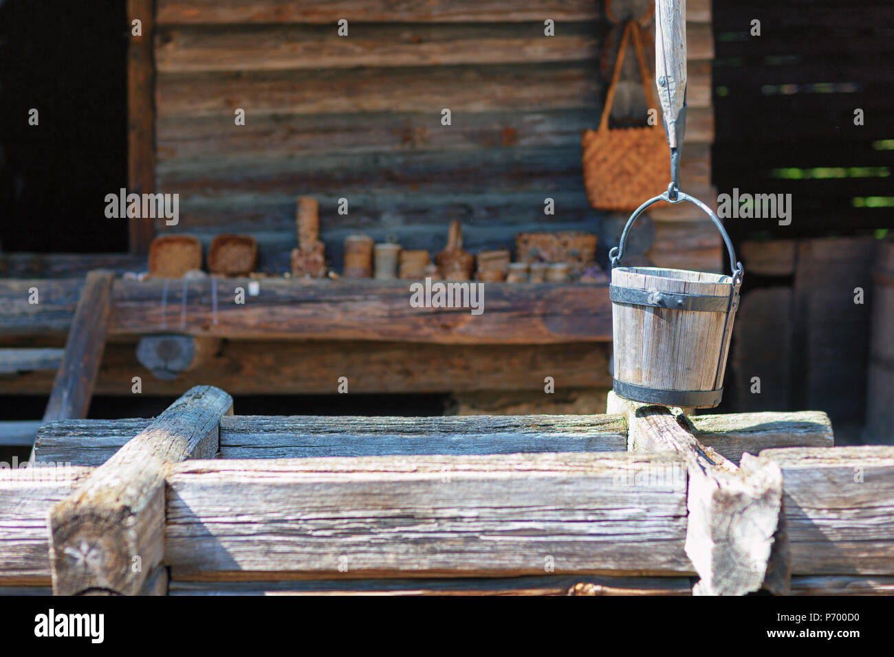 Wooden bucket with iron hoops on the well of a crane against the ...