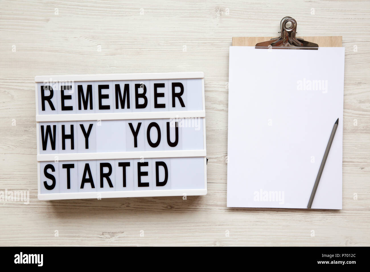 Noticeboard, pencil and 'Remember why you started' words on lightbox ...
