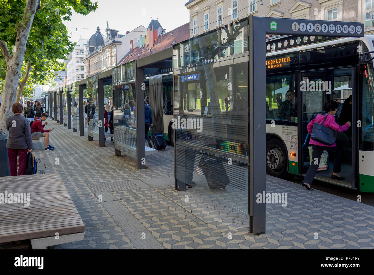 Bus passengers await the next service on Slovenska Cesta (street) in ...