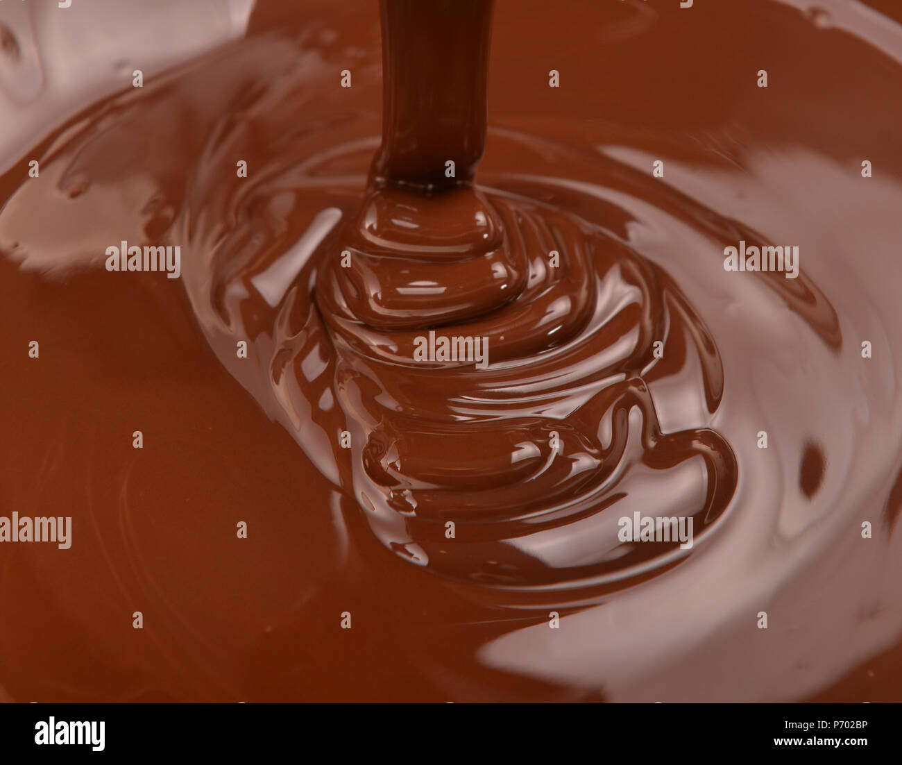 Melted chocolate pouring from cooking hi-res stock photography and ...