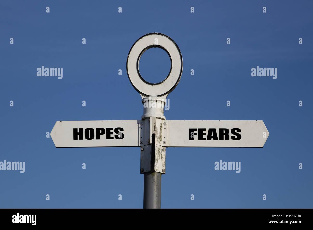 Old road sign with heaven and hell pointing in opposite directions ...