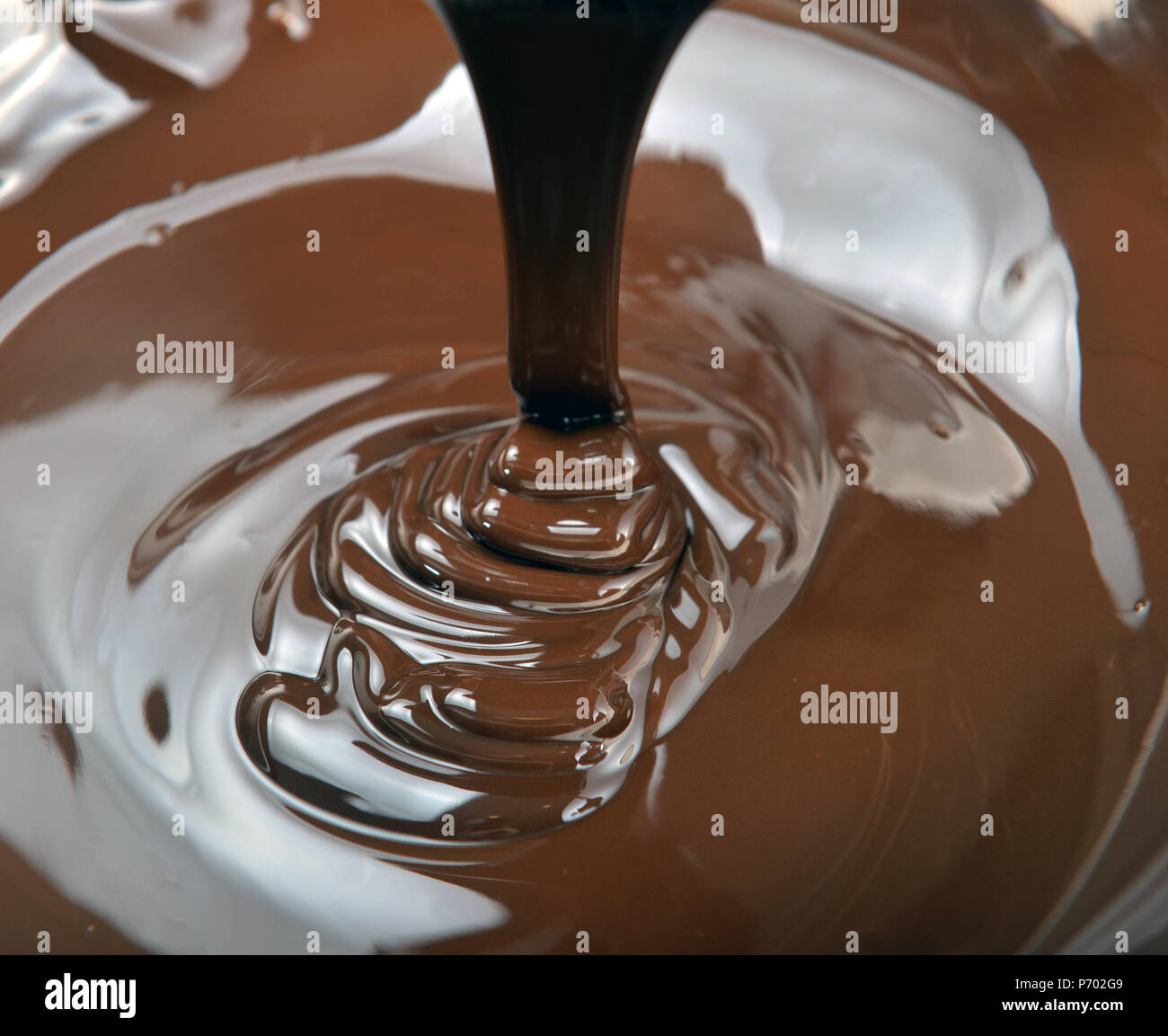 Melted chocolate pouring from cooking hi-res stock photography and ...