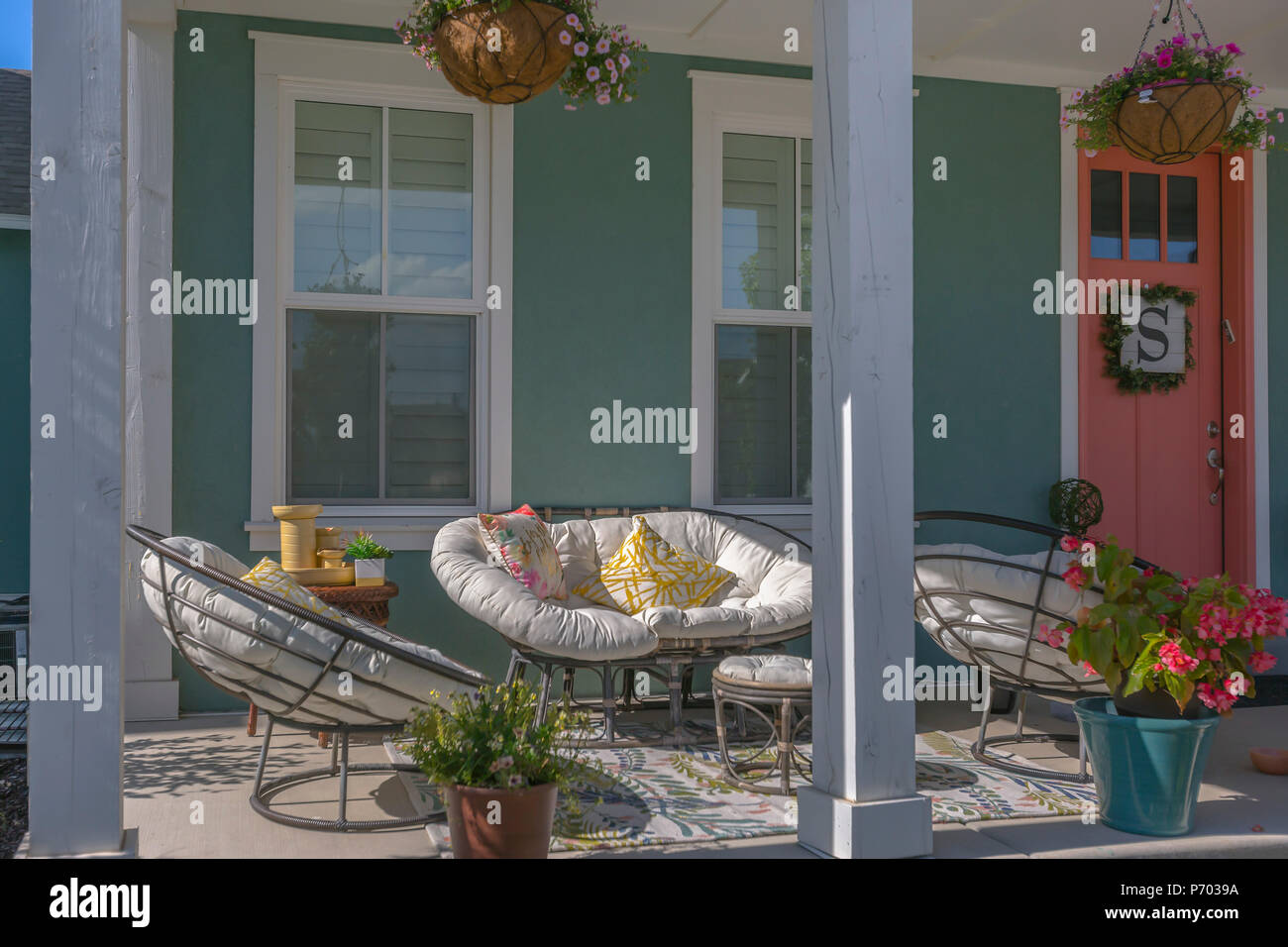 Porch seating area outside of red front door Stock Photo - Alamy