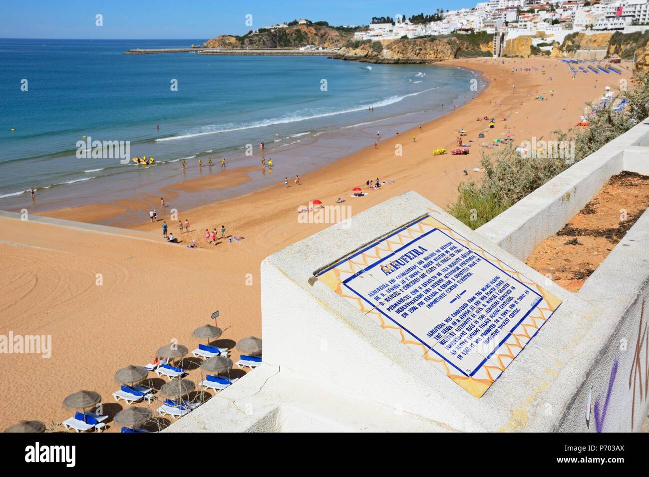 Historical information ceramic sign with views of tourists relaxing on ...