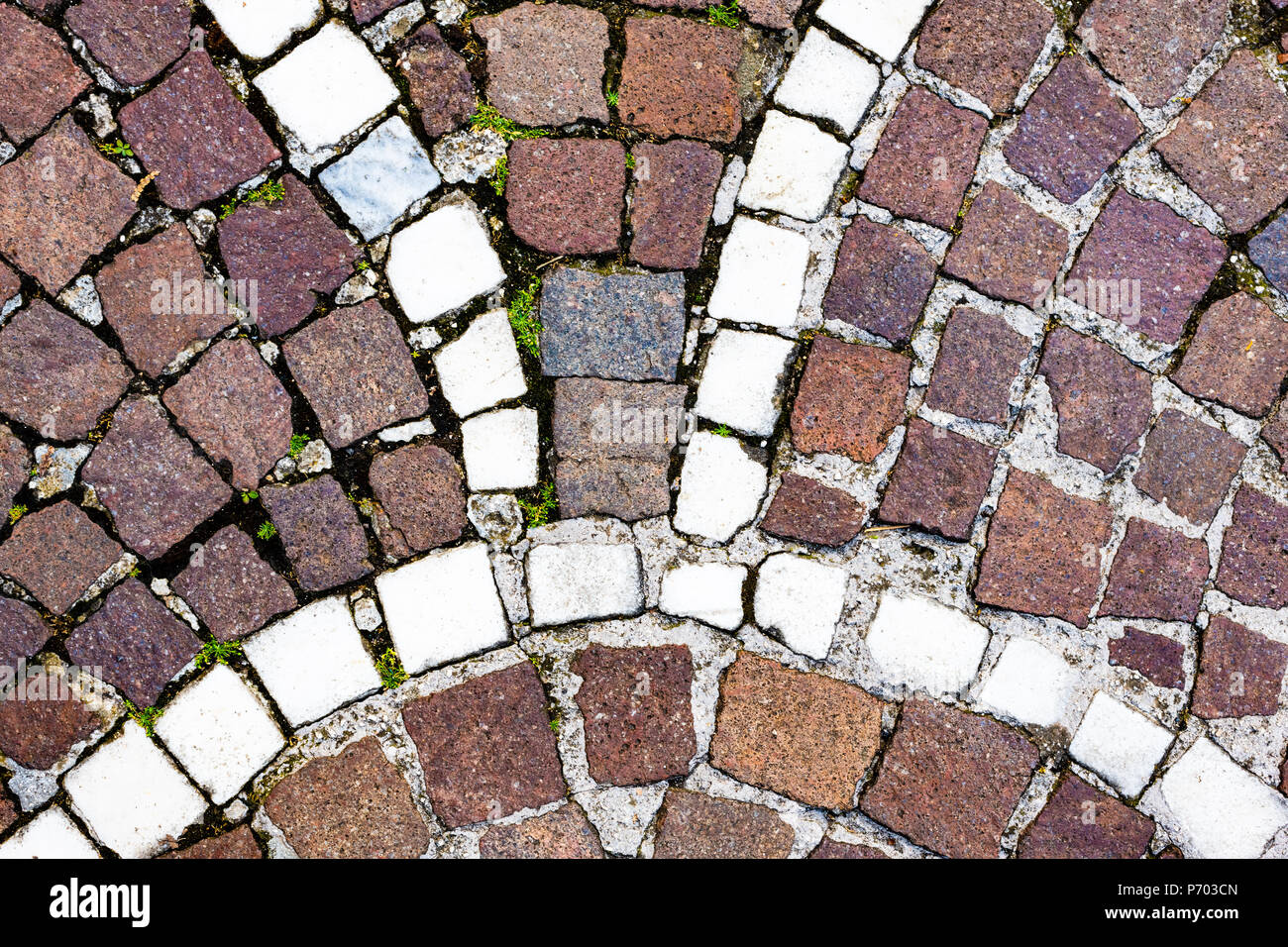 Detail of old aged urban cobblestone footpath background full frame ...