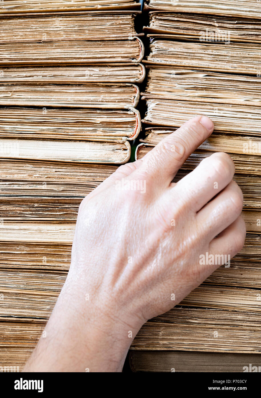 Stack of old vintage aged books stack human hand on the books Stock ...