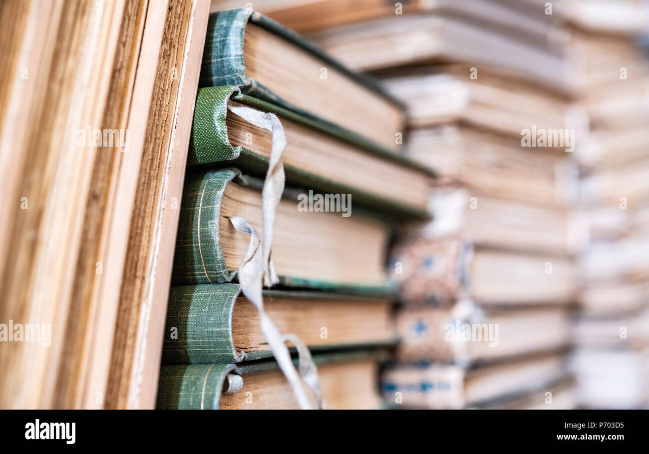 Stack of old vintage aged books stack selective focus detail on old ...