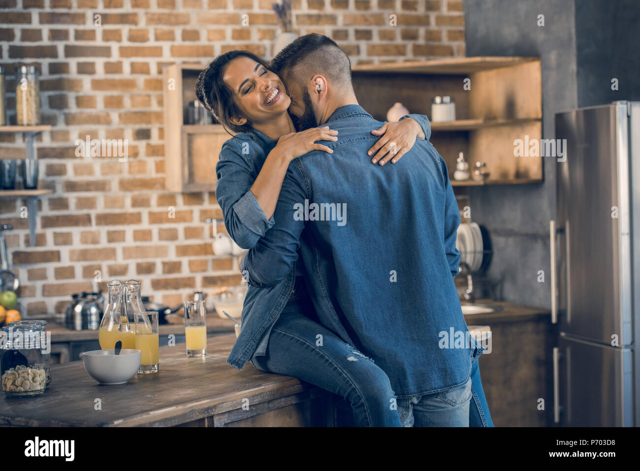 Passionate young couple hugging on kitchen table during breakfast Stock ...