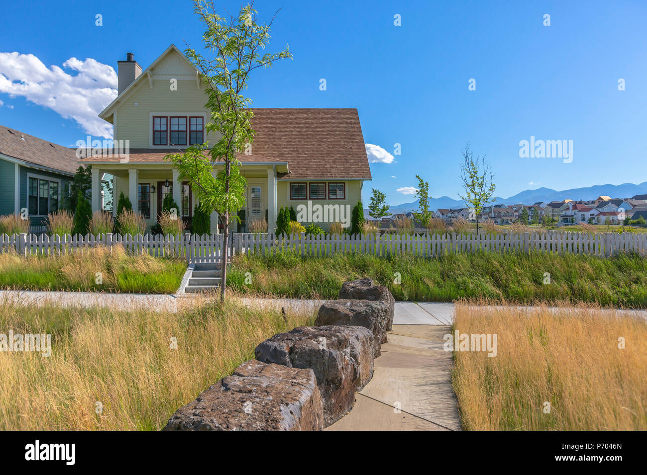 Rocks lining walkway between homes in neighborhood Stock Photo - Alamy