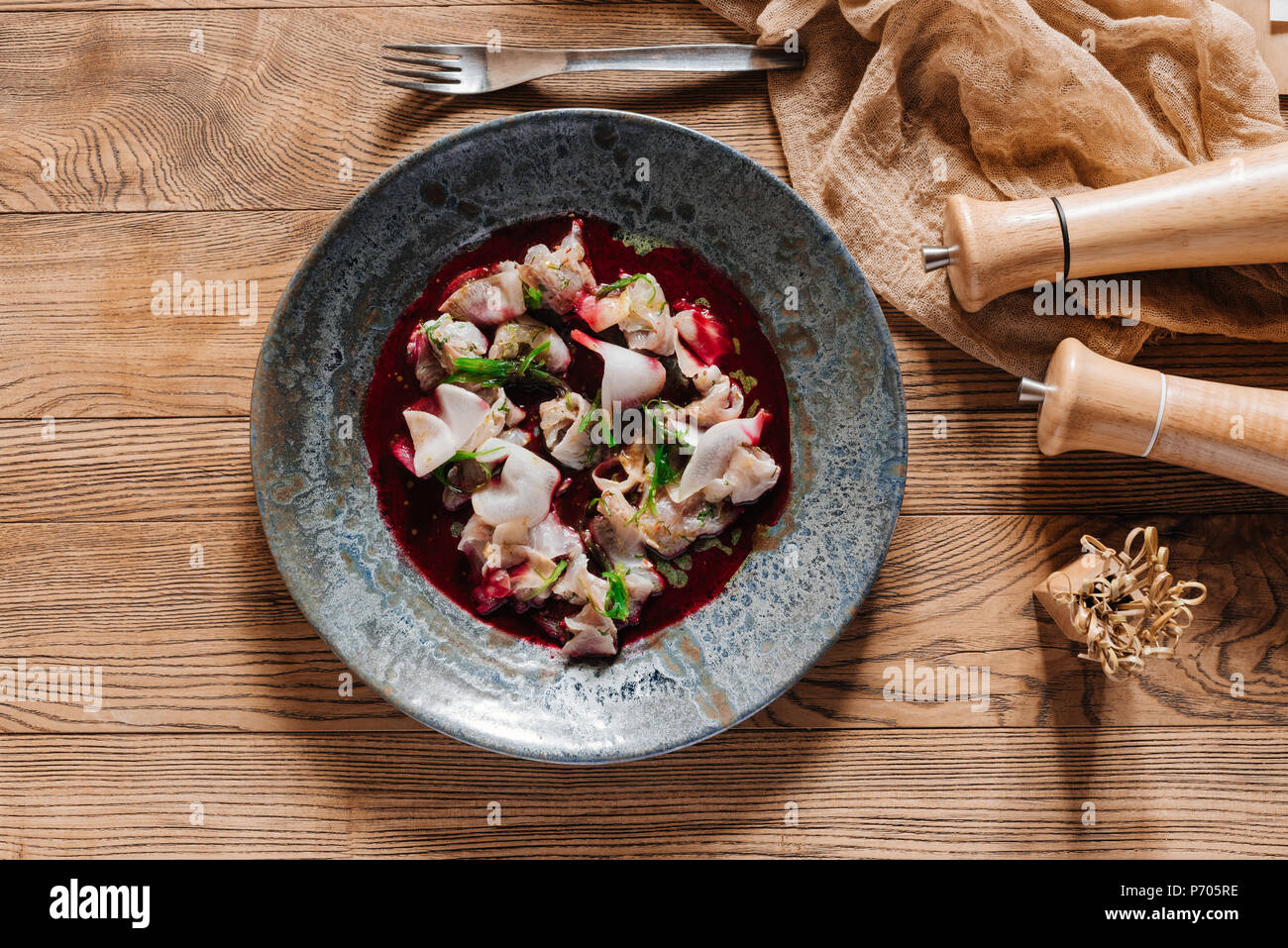 top view of delicious Ceviche with dorado and spices on wooden table ...