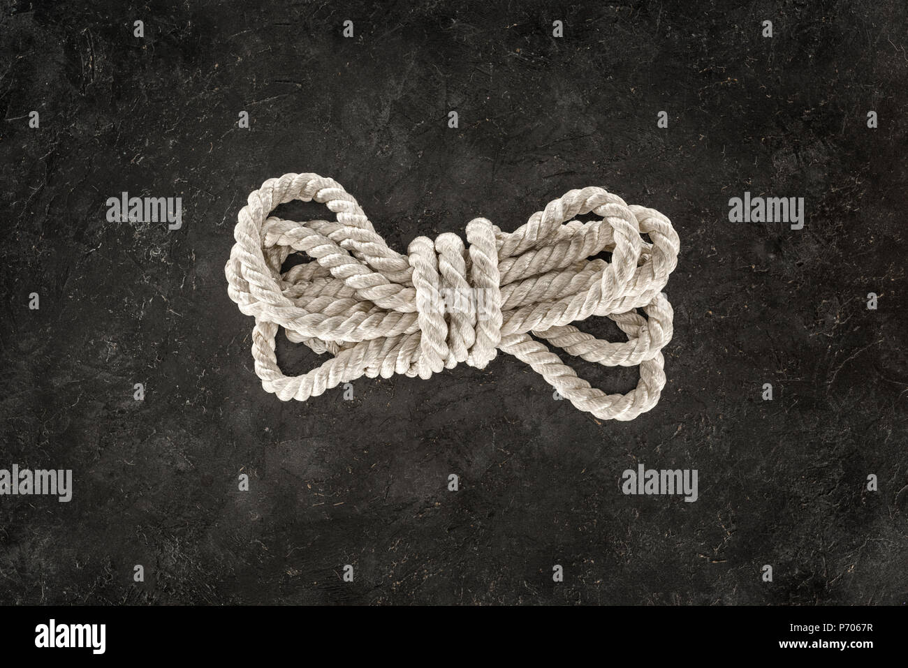 top view of tied white nautical rope on dark concrete tabletop Stock ...