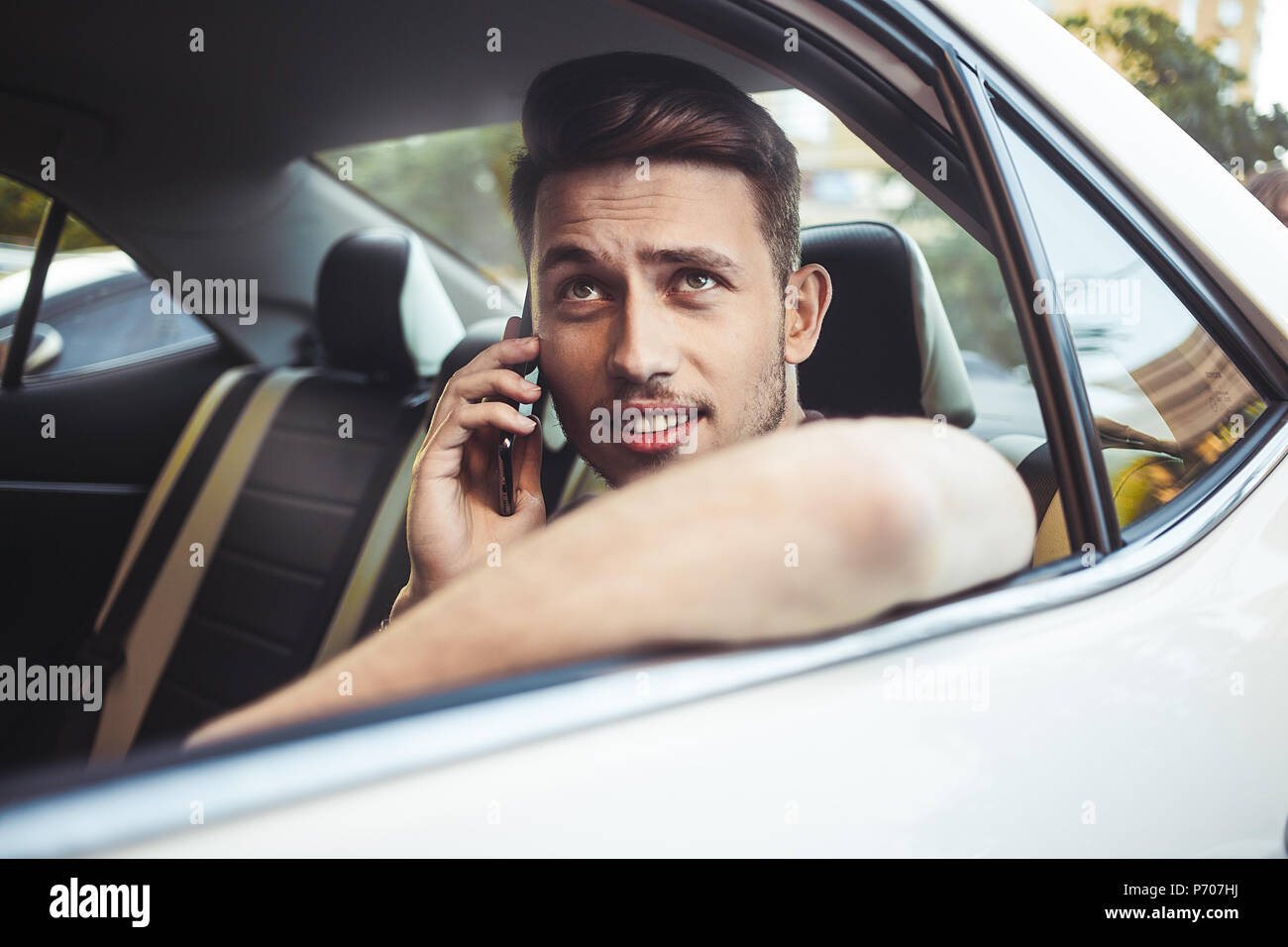 Enjoy the drive. Image of young handsome guy sitting in car Stock Photo ...