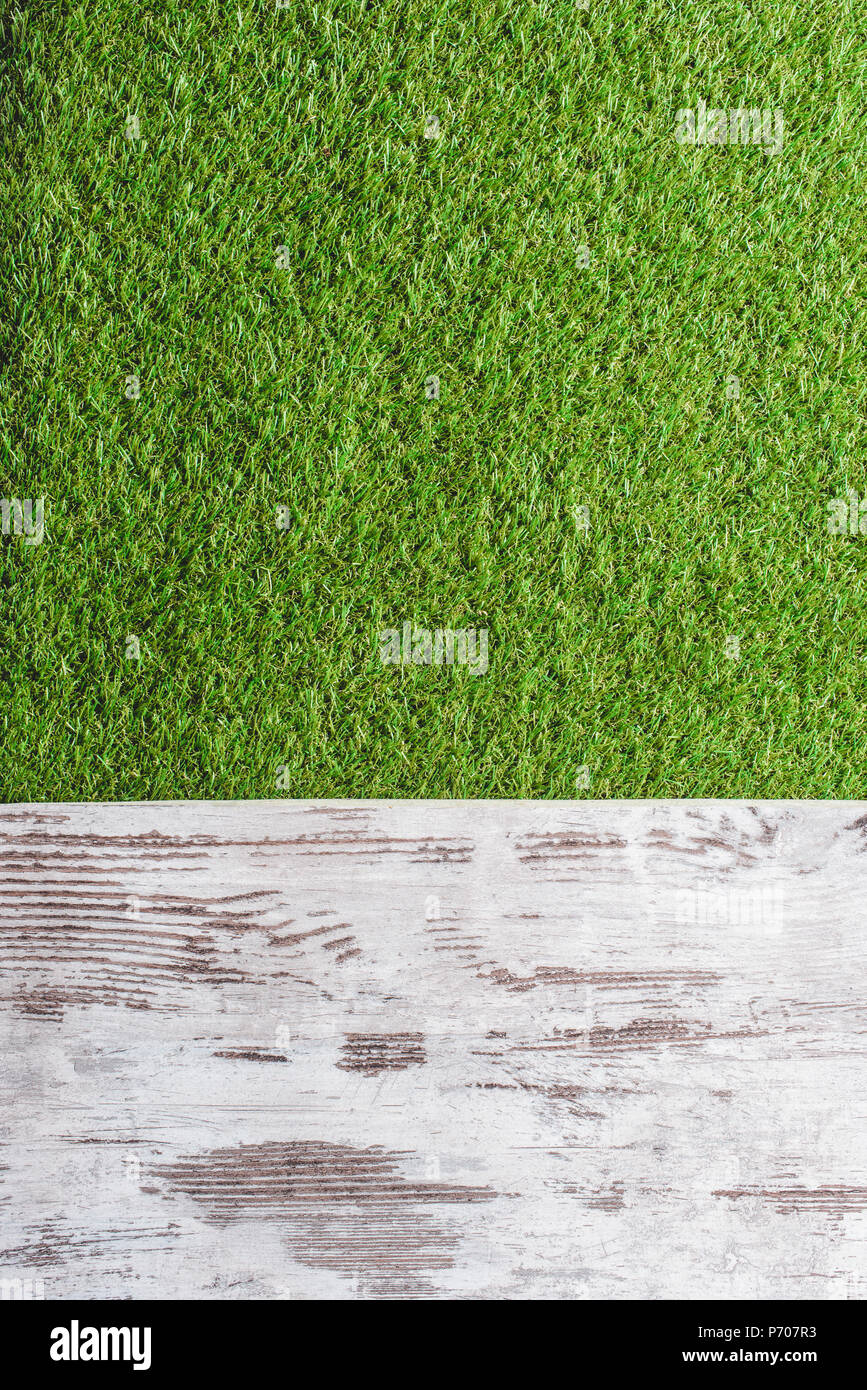 top view of green lawn and wooden planks background Stock Photo - Alamy