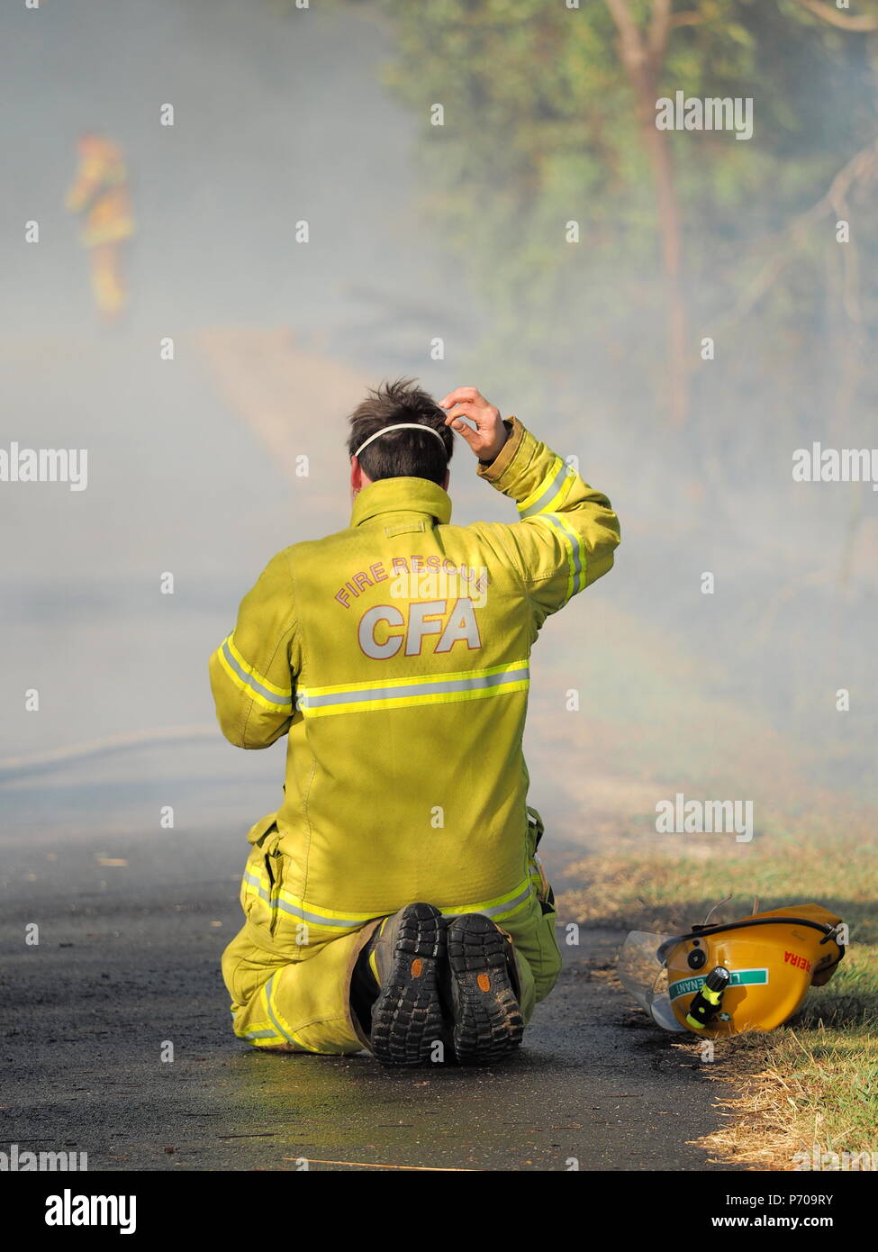 Melbourne, Australia - April 13, 2018: Exhausted Fire fighter at a bush ...