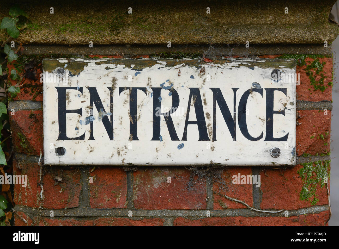 Entrance sign on wall Stock Photo - Alamy