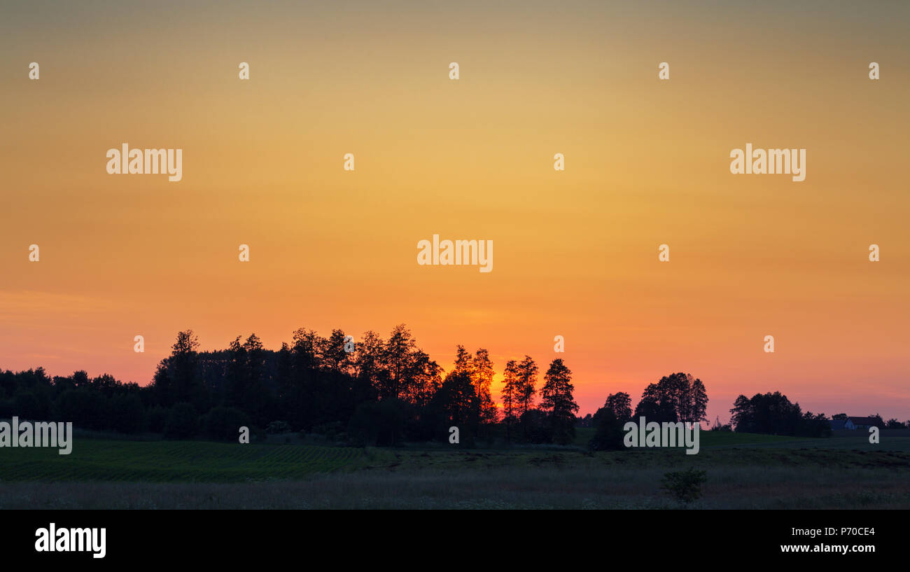 Warm orange sunset sky over farming fields in East Europe Stock Photo ...