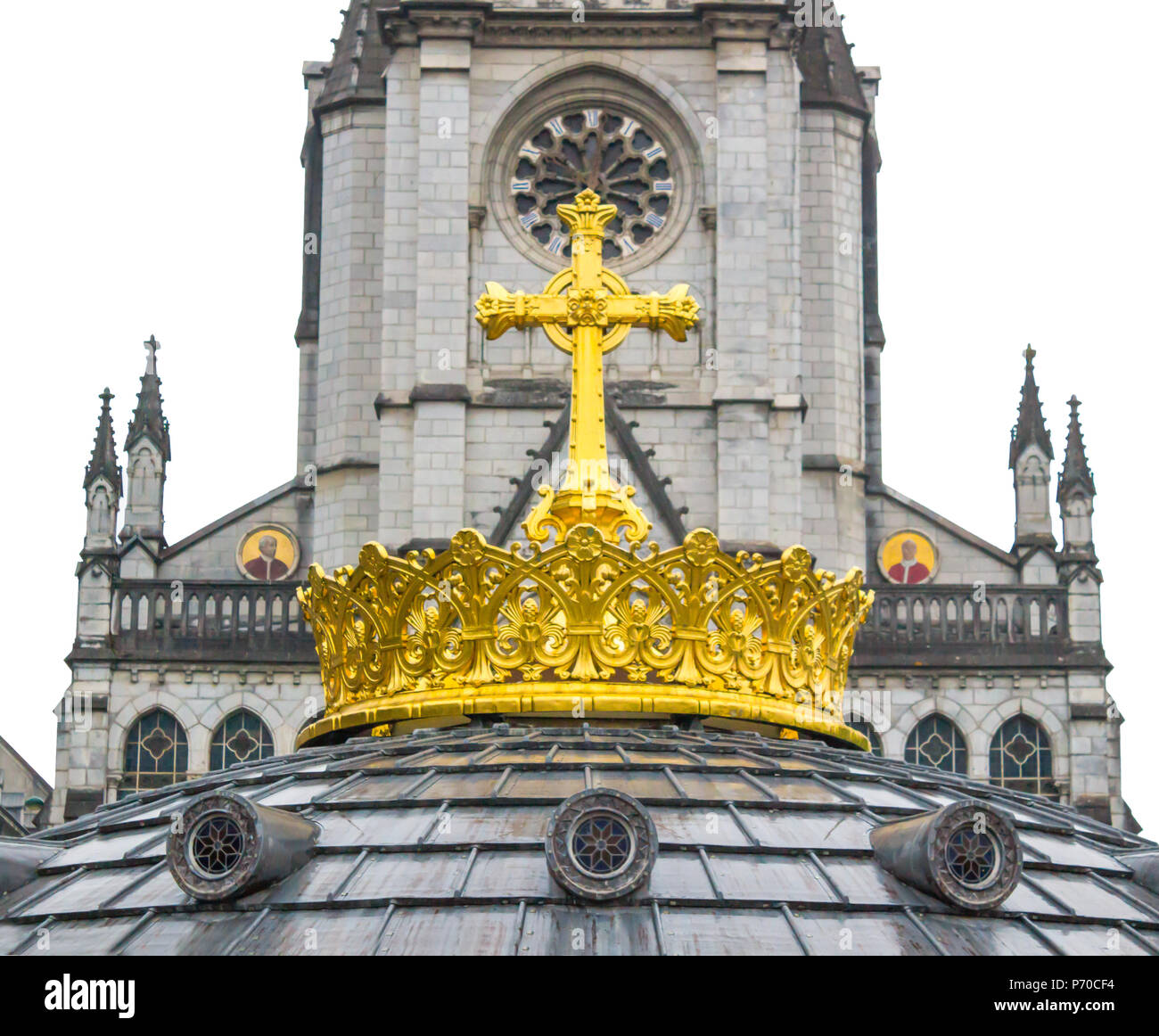 Golden cross and crown in lourdes france with dark sky Stock Photo - Alamy