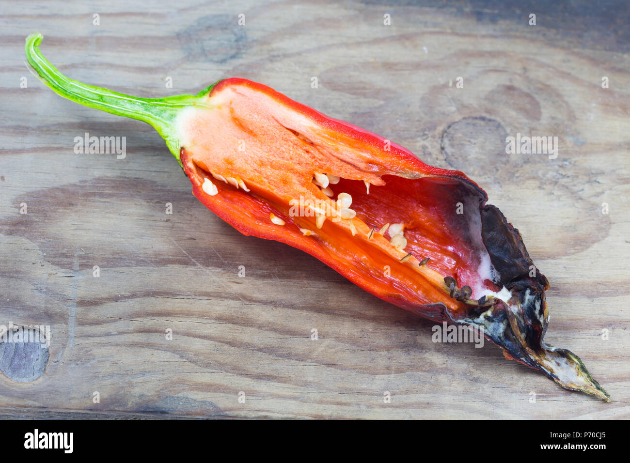 moldy of red chili pepper on wooden background / Rotten red chili ...