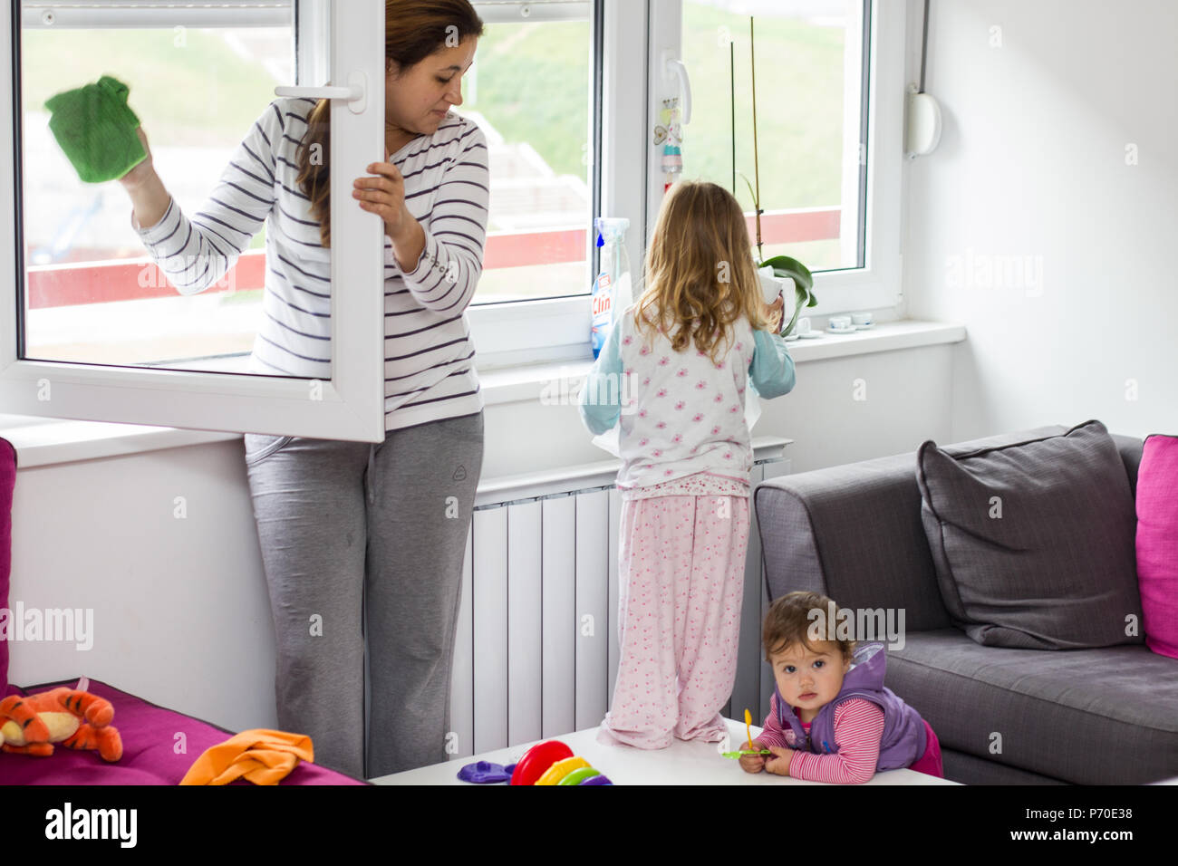 Family Housework, Young mother cleaning house with her daughters Stock ...
