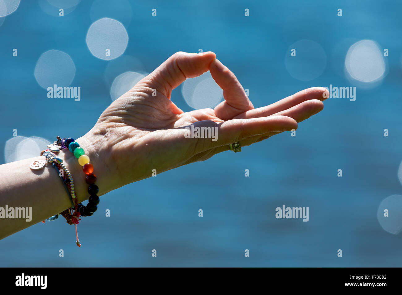 A yoga instructor demonstrates yoga poses during an outdoor yoga ...