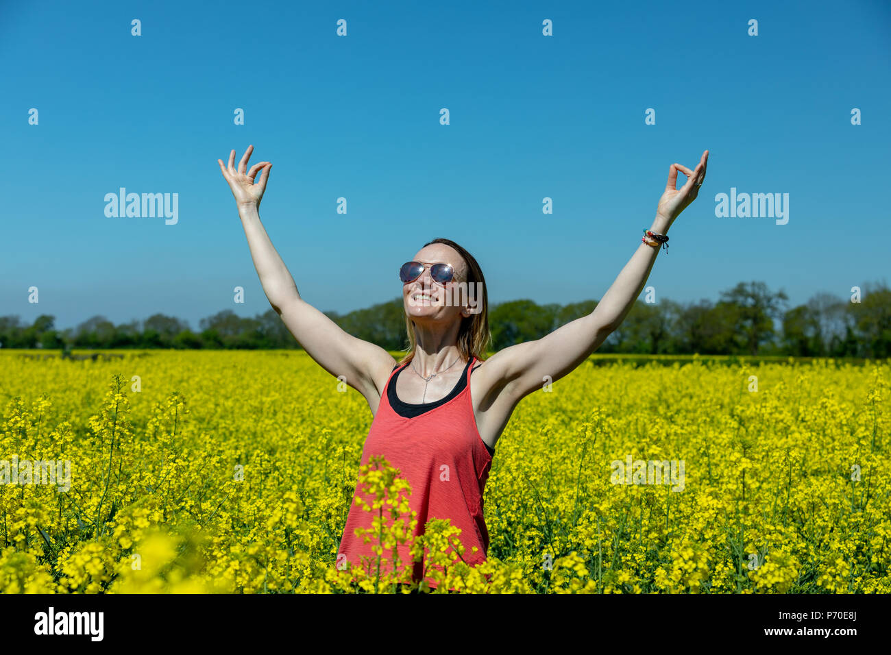 A yoga instructor demonstrates yoga poses during an outdoor yoga ...