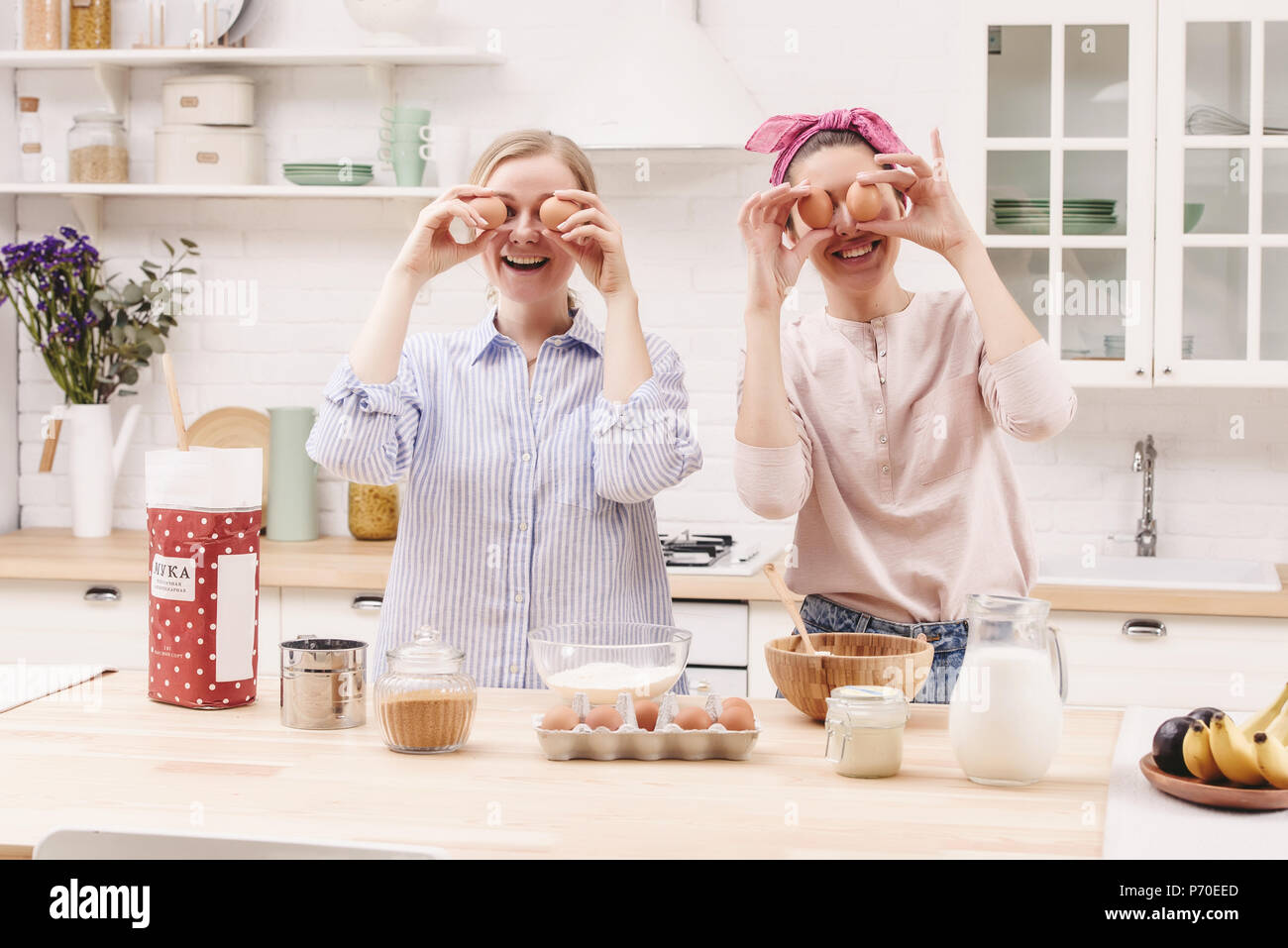 Cheerful women preparing breakfast together in the kitchen Stock Photo ...