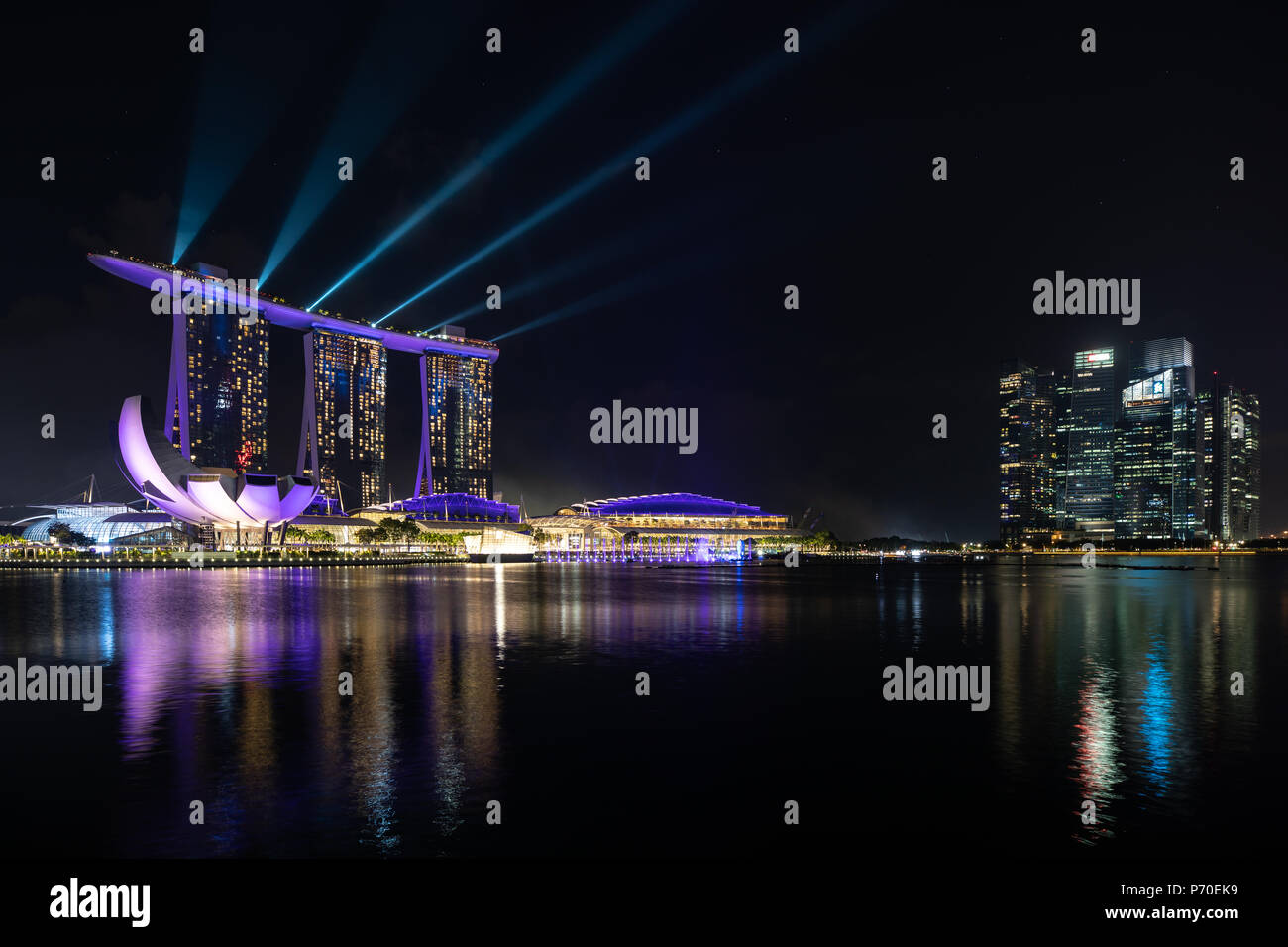 Marina Bay skyline and its reflection in the water after sunset with ...