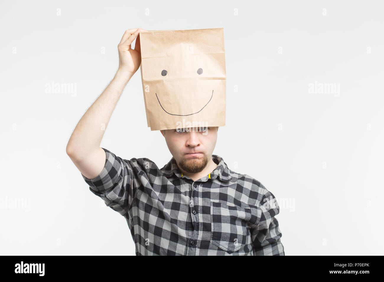 Angry white men wearing happy paper bag mask on white background Stock ...