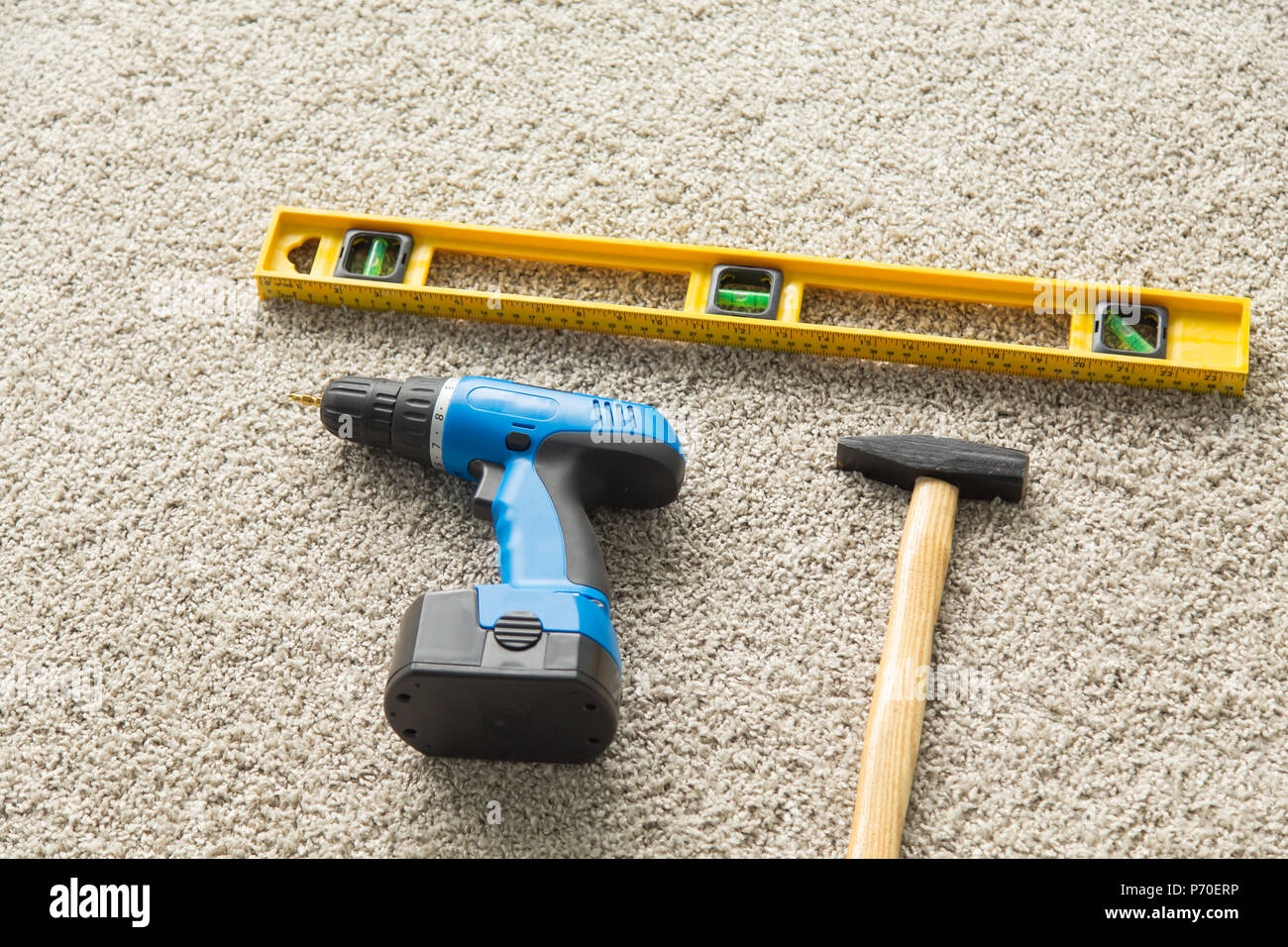 Construction concept - Hammer, drill and builders level on the floor ...