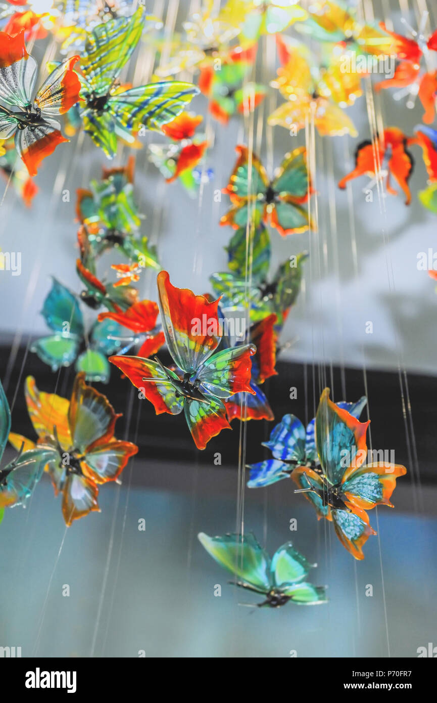 Glass colorful butterflies hang in the shop window Stock Photo - Alamy